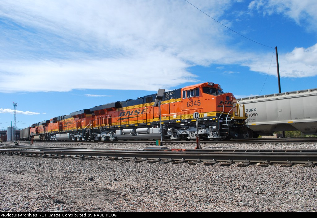 BNSF 6345 and BNSF 6347 roll past me going north with Coors Field in downtown Denver, Co as the ...